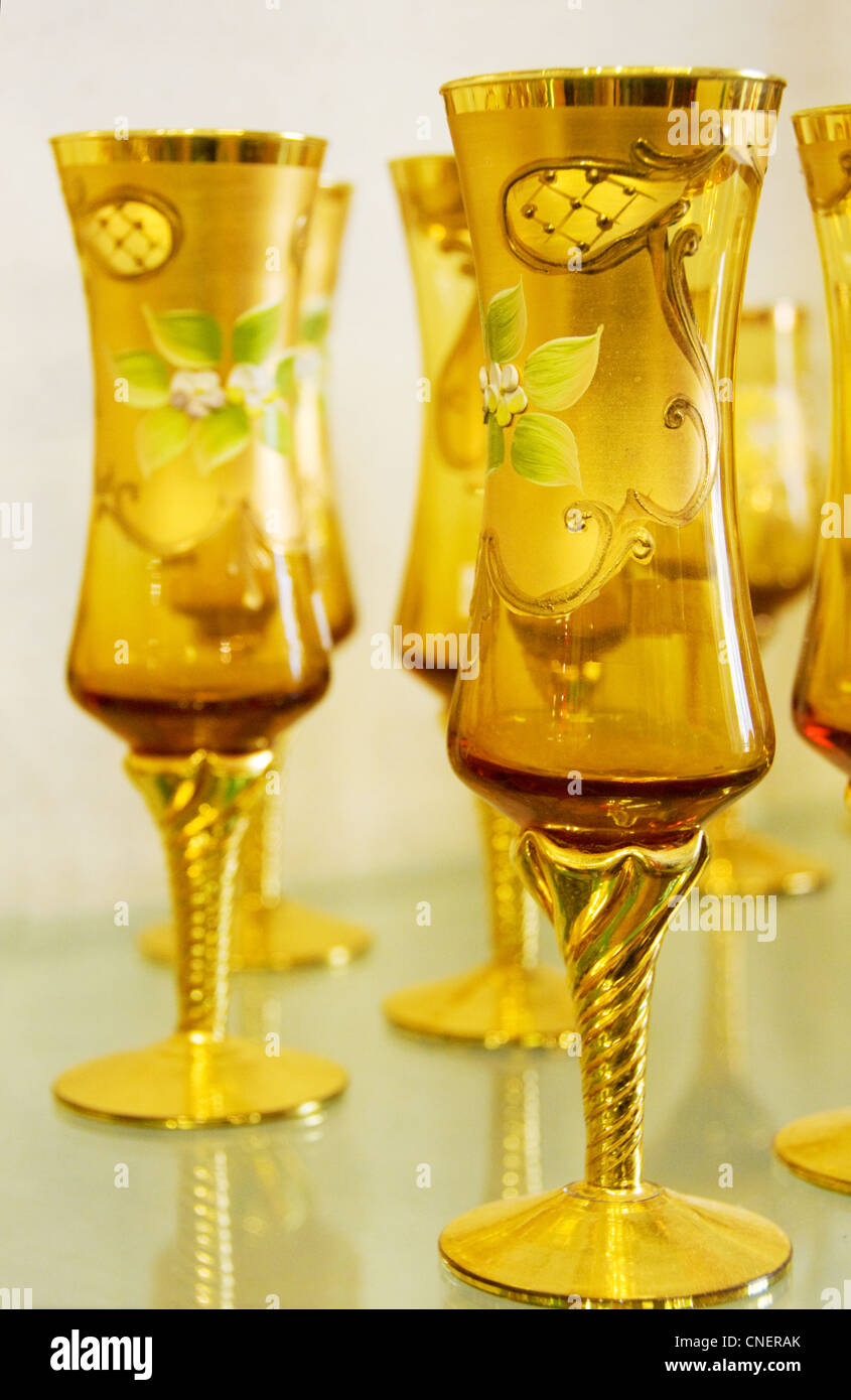 Transparent gold tall hand-made glass covered with gold drawing ...