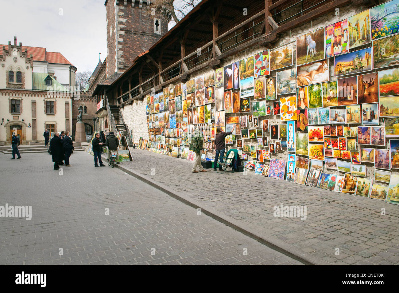 Paintings for sale on the wall of Florianska Gate in Cracow, Poland ...