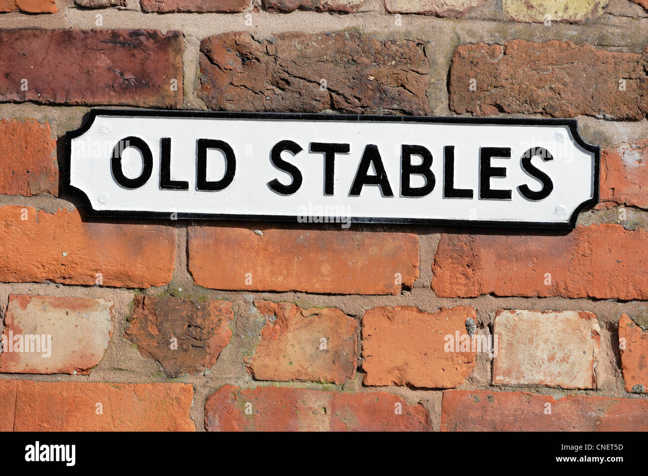 A stables sign on a red brick wall Stock Photo - Alamy