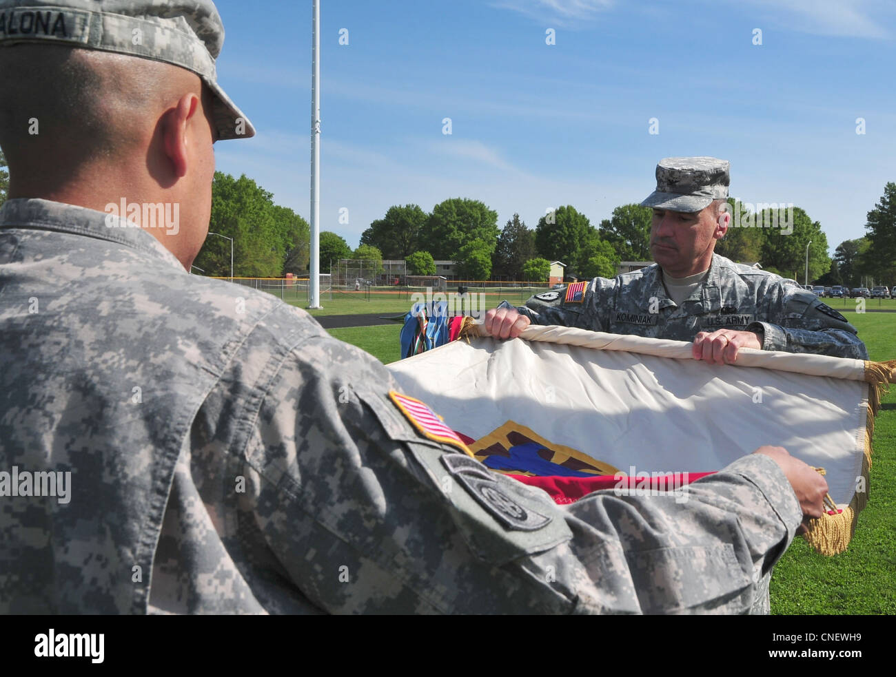 Colonel Lawrence Kominaik, 7th sustainment brigade commander, unfurls ...
