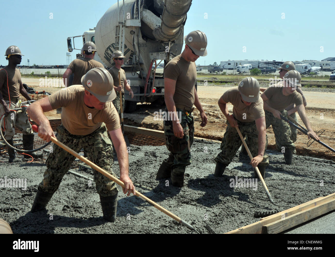 Naval Mobile Construction Battalion 133 Seabees level concrete within a ...