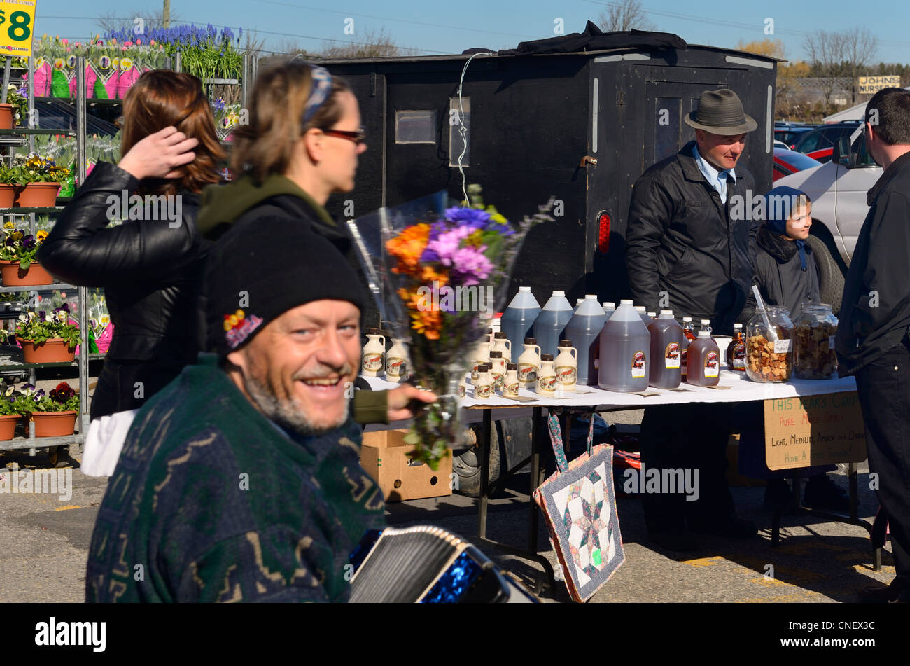 Smiling accordion busker and Mennonite Maple Syrup seller at the ...