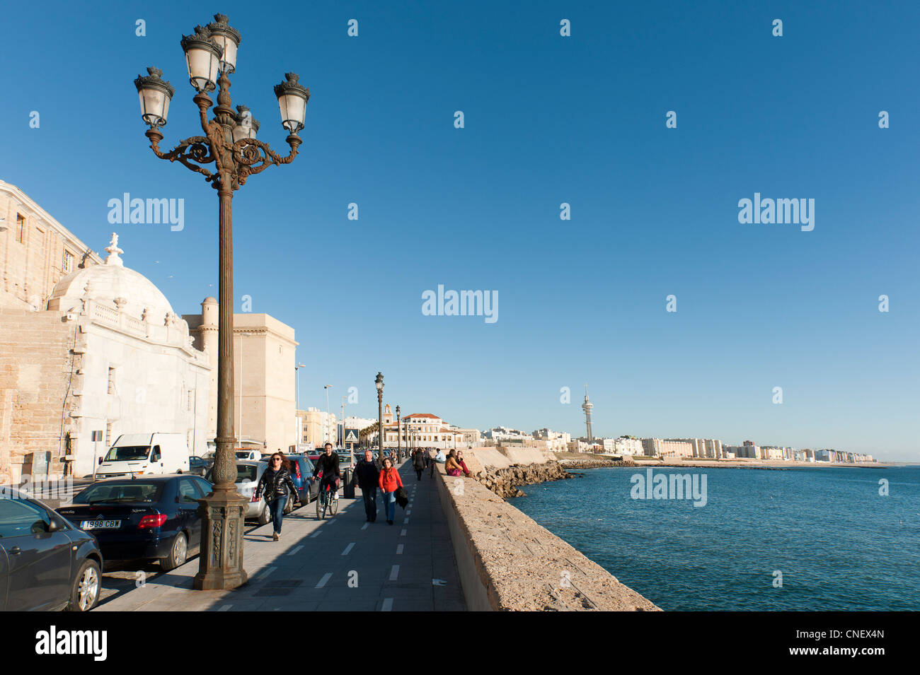 People take a walk along the waterfront of Cadiz, Andalusia, Spain ...