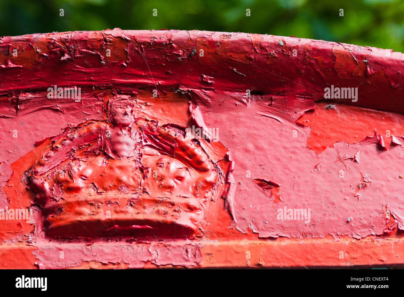Peeling paint on a Royal Mail post box indicating the state of the ...