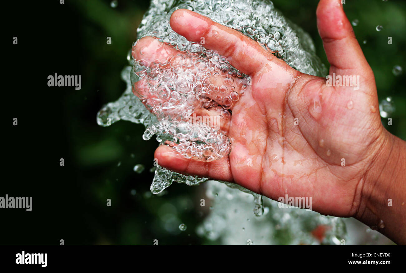 Fresh clean and pure bubbling water splashing on hand Stock Photo - Alamy