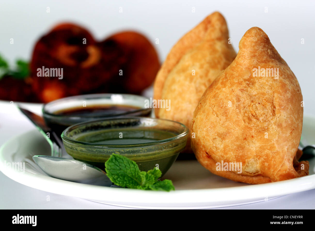 Popular indian, asian and african deep fried snack called samosa with ...