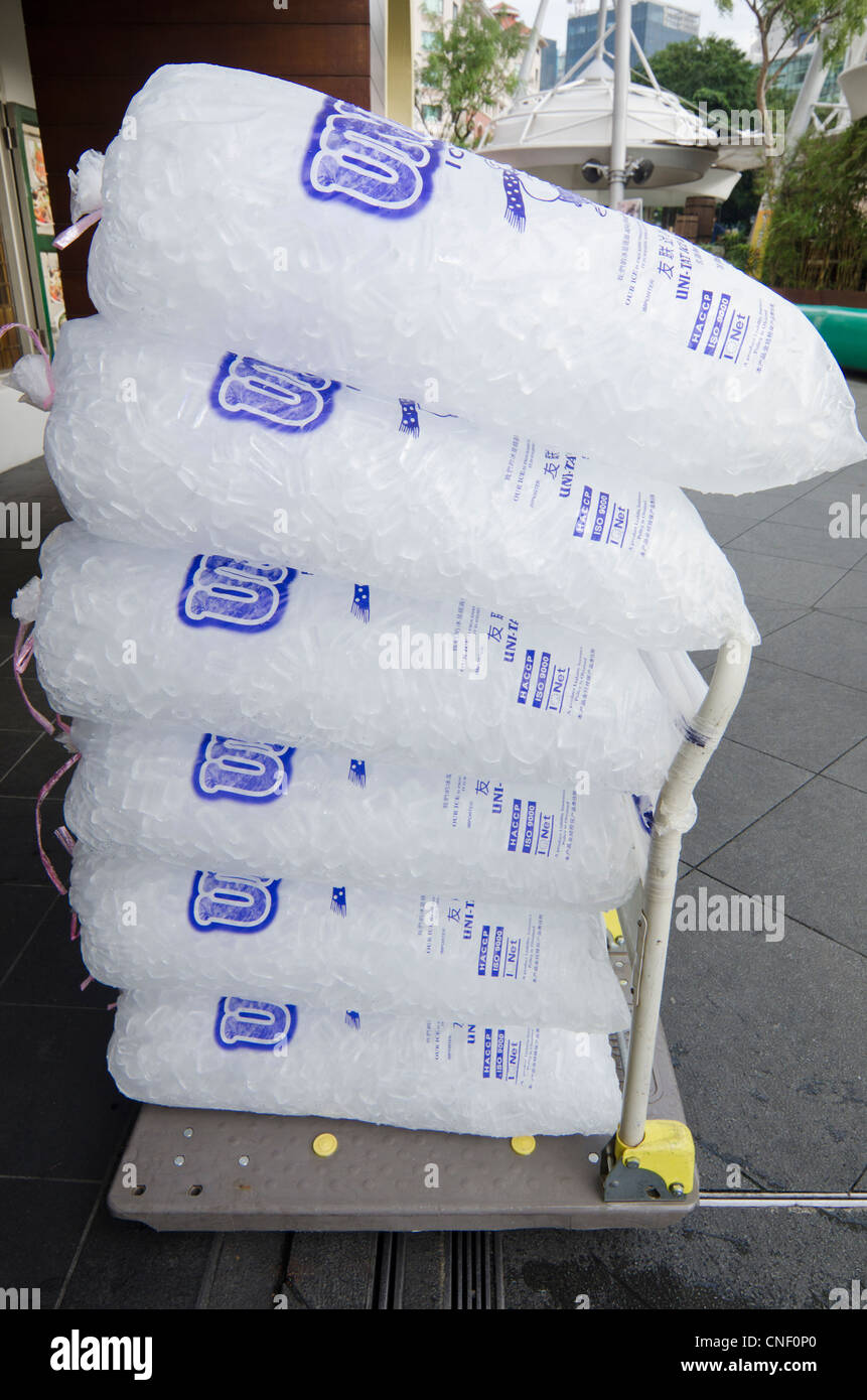 Stack of bags of commercial ice on a trolley Stock Photo - Alamy