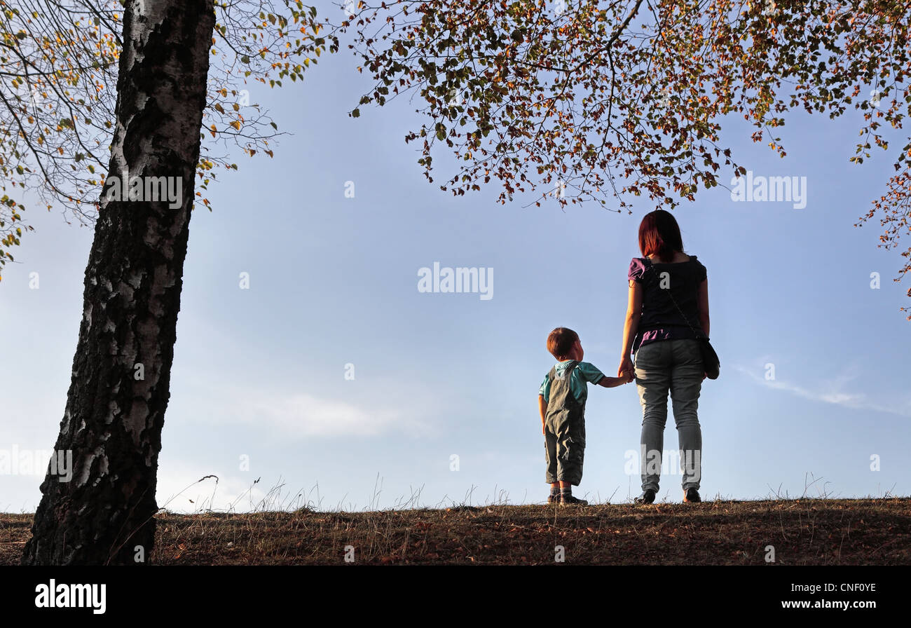 Happy active family in autumn park Stock Photo - Alamy