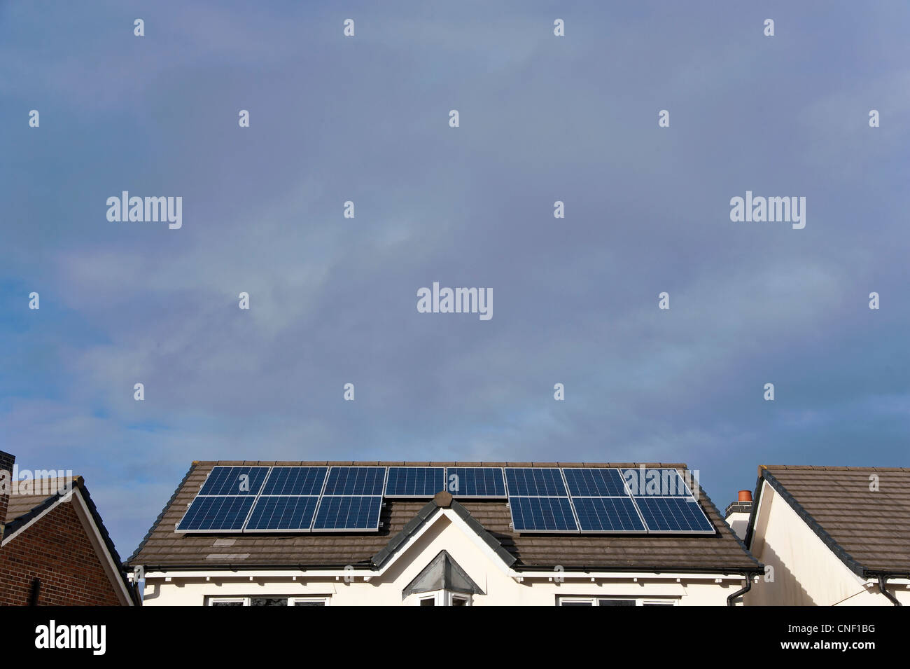 Solar PV cell array on a house rood, with a gloomy sky Stock Photo - Alamy