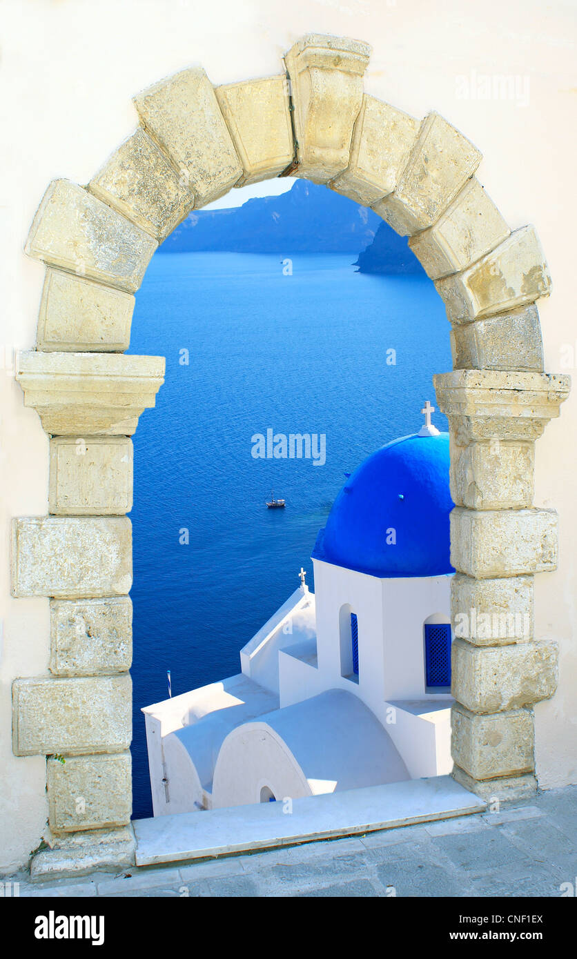 Traditional greek church through an old window in Santorini island ...