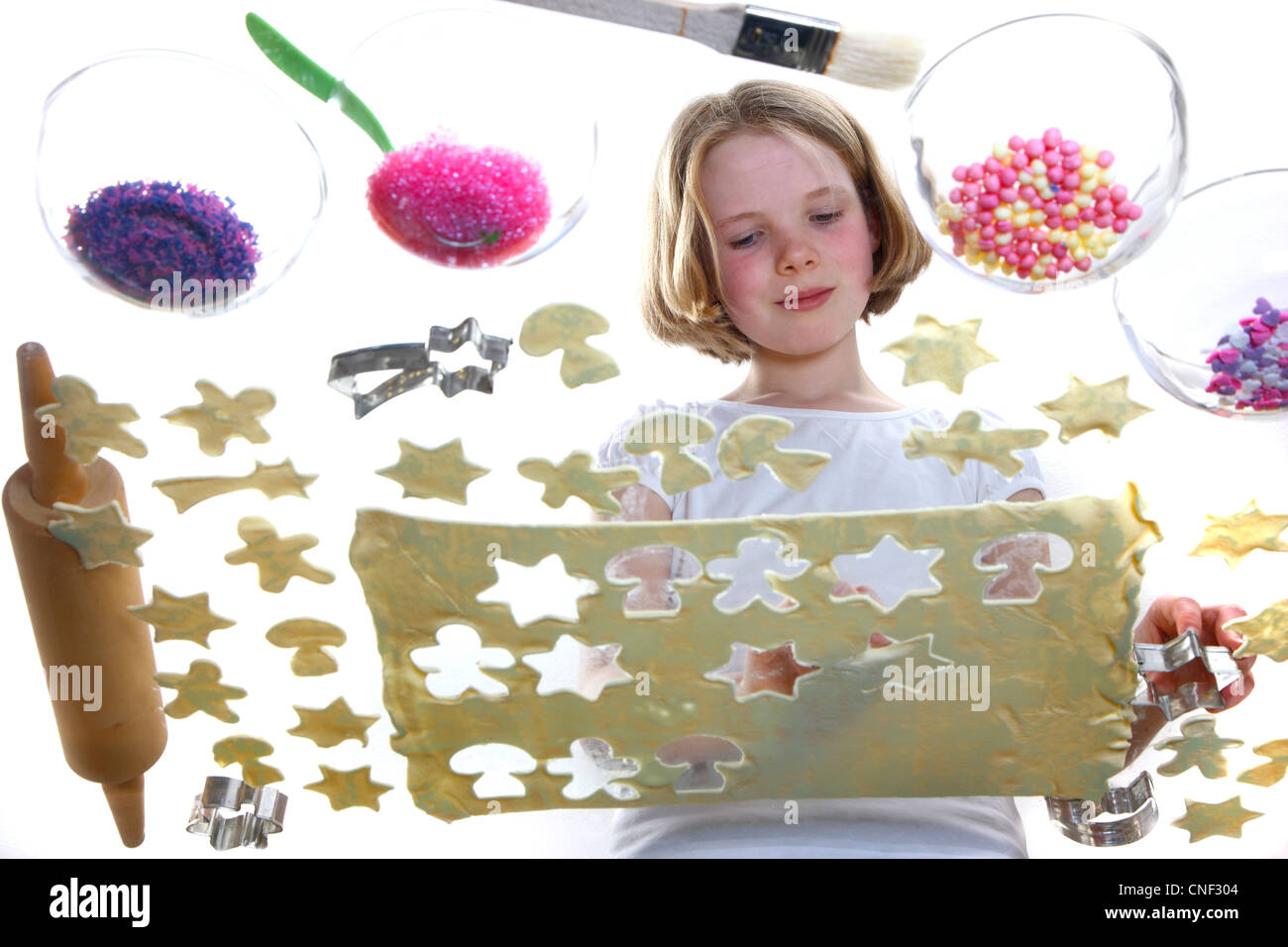 Young Girl Is Baking Cookies Cutting Out The Cookie Dough In Different young-girl-is-baking-cookies-cutting-out-the-cookie-dough-in-different