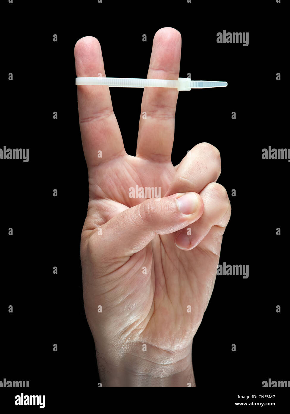 Hand is showing a victory sign with a zip tie on fingers on a black ...