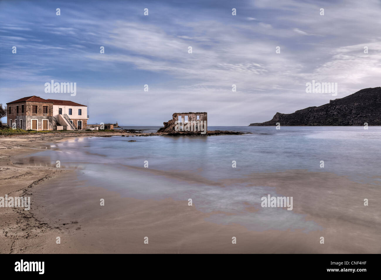 The ruins of a house in the middle of the sea in the village Plytra in ...