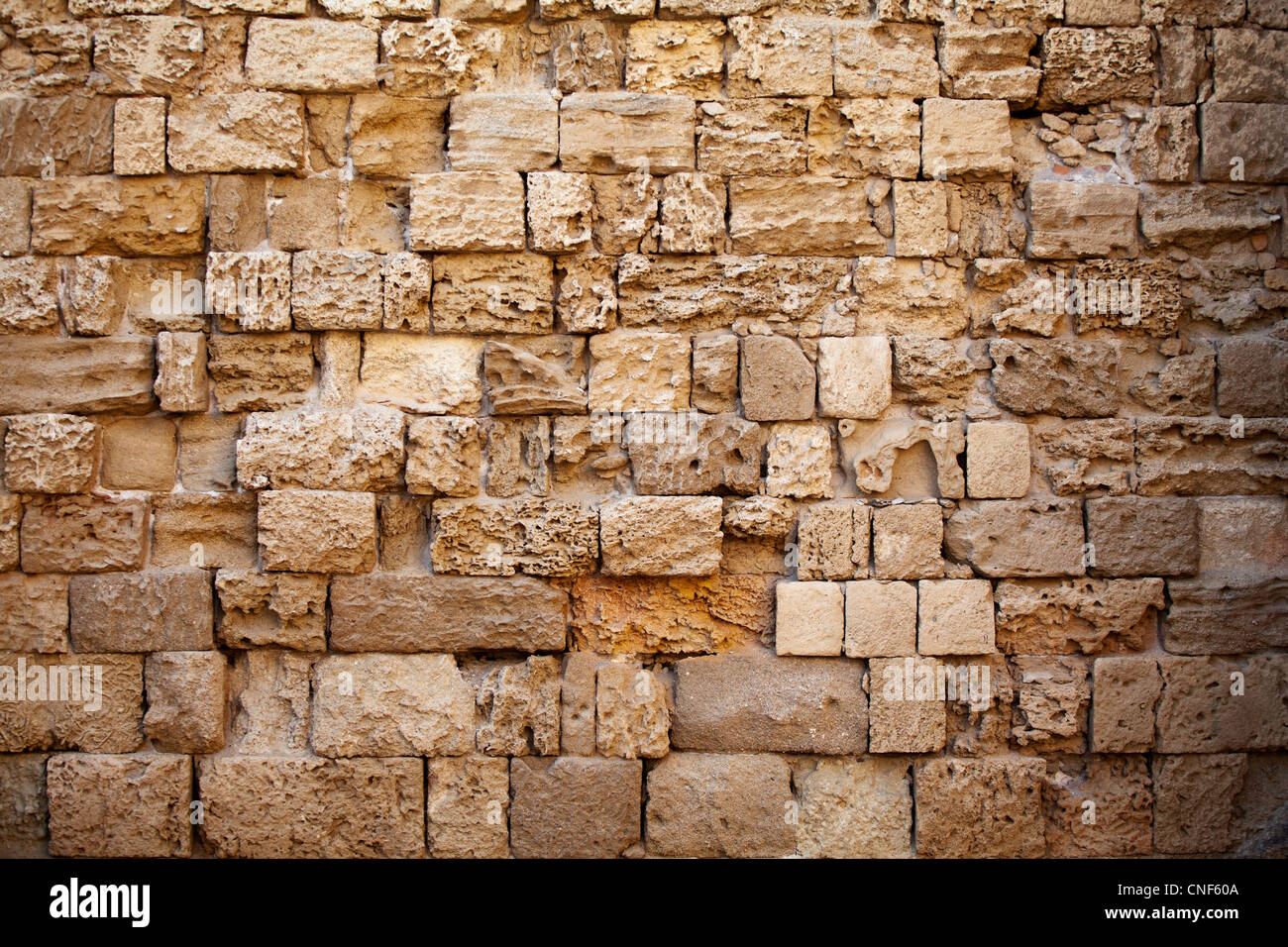 Traditional greek wall made of yellow rocks. Sides of Rhodes Stock ...