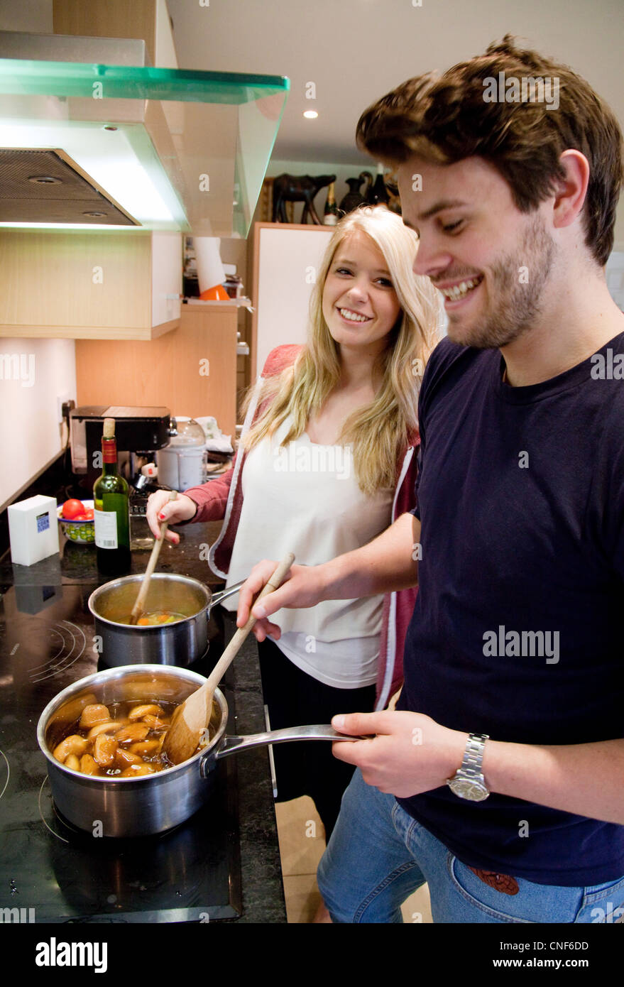 Young couple cooking in the kitchen, UK Stock Photo - Alamy