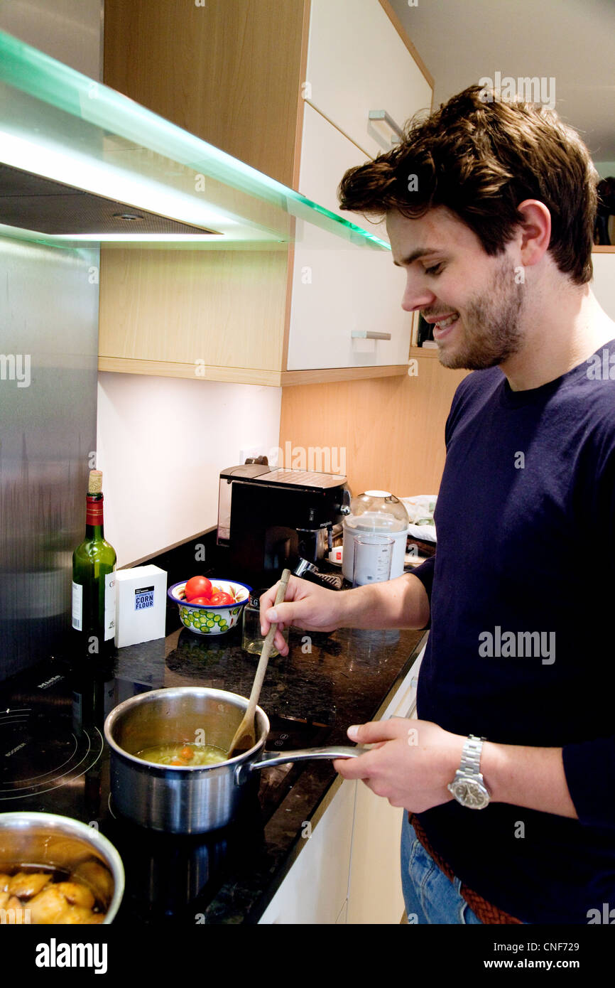 Young man cooking in the kitchen, UK Stock Photo - Alamy