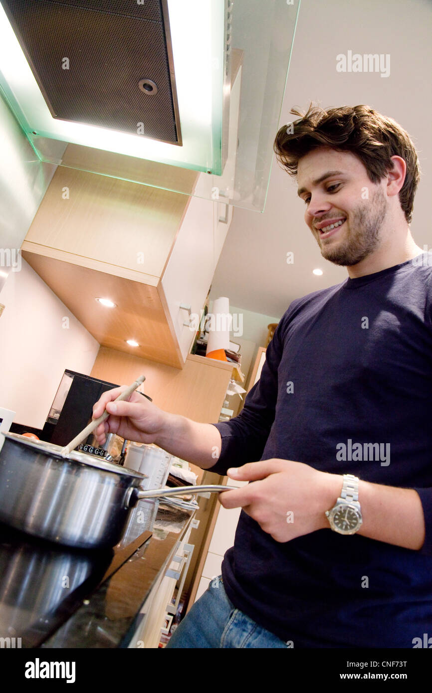 Young man cooking in the kitchen, UK Stock Photo - Alamy