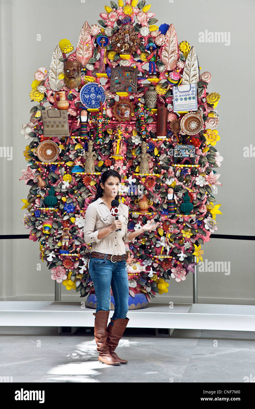 pretty Mexican television reporter stands in courtyard of Museo de Arte ...
