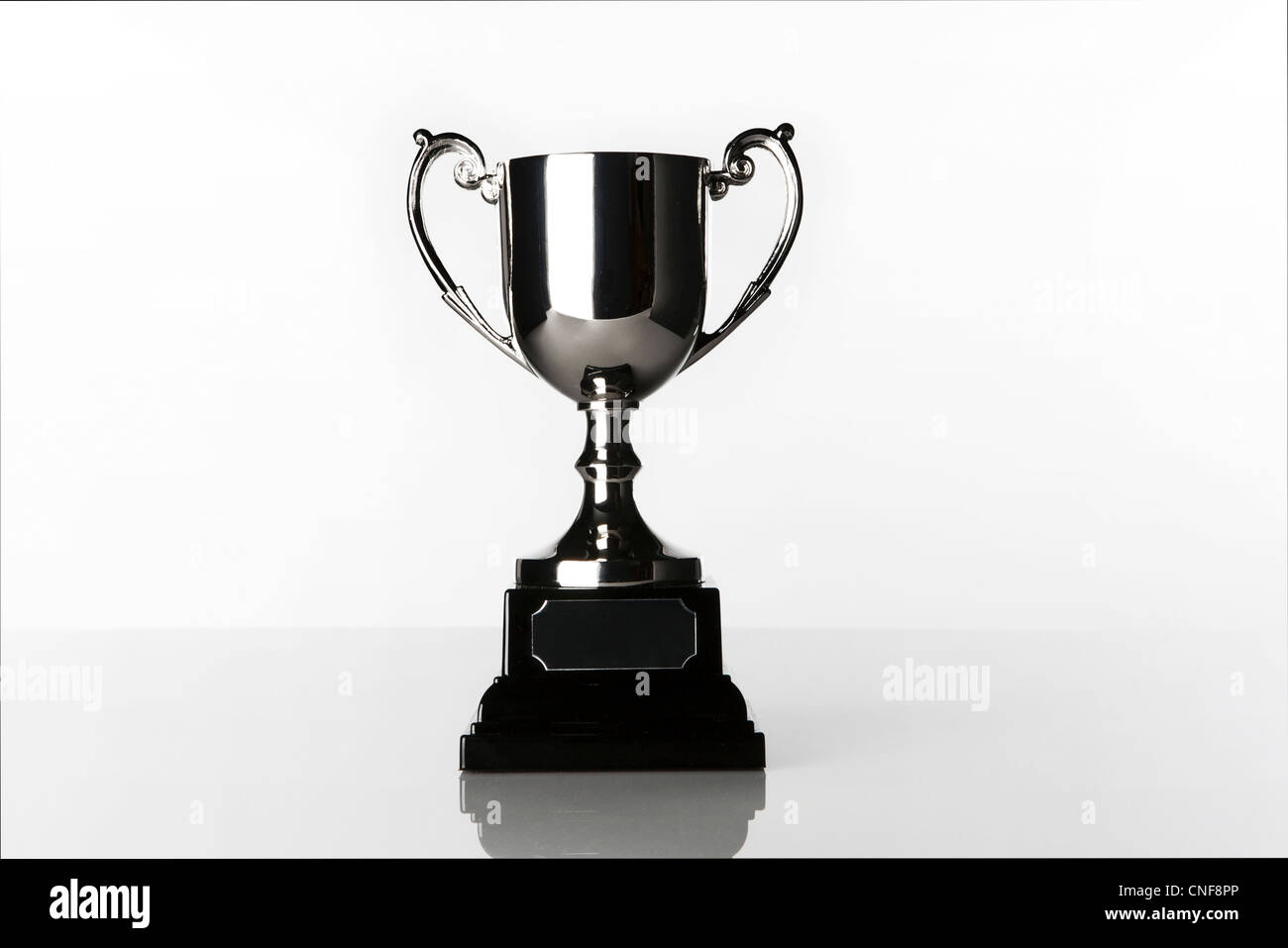 still life image of a single trophy standing in a white background ...