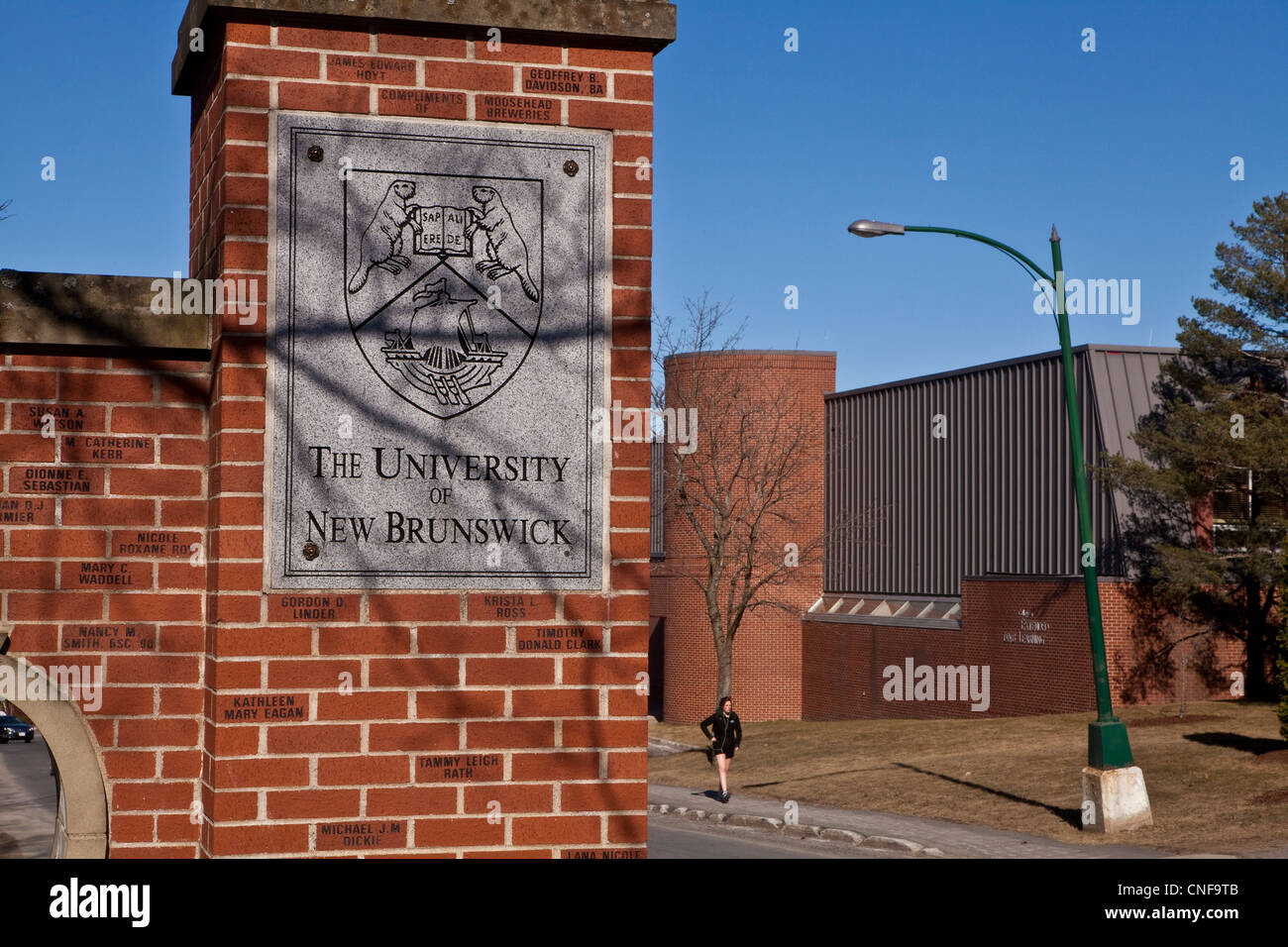 A student walks by University of New Brunswick (UNB) gate in ...