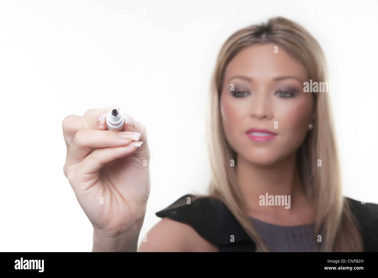 attractive business woman writes with a marker pen Stock Photo - Alamy
