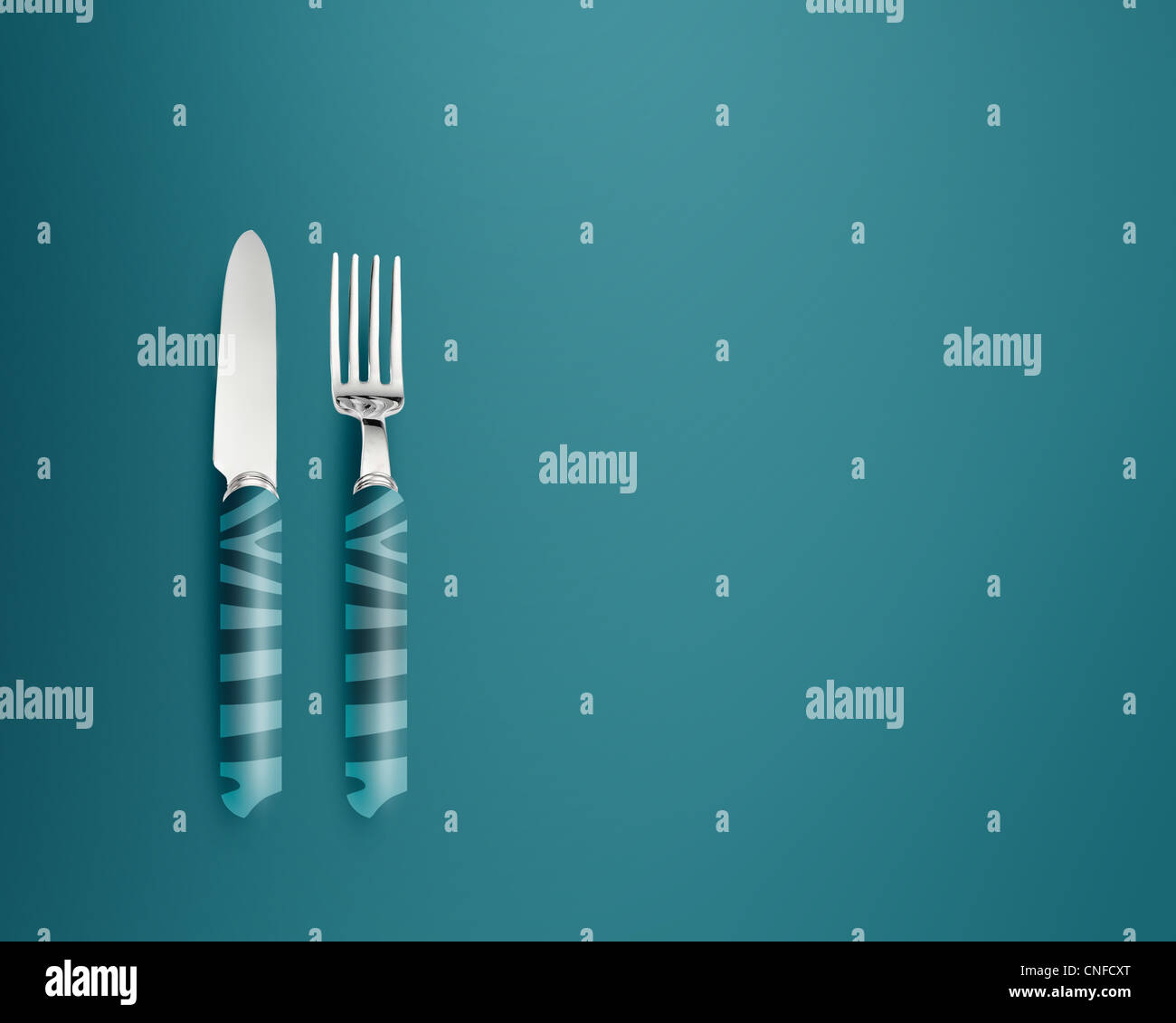 knife and fork on blue background Stock Photo - Alamy