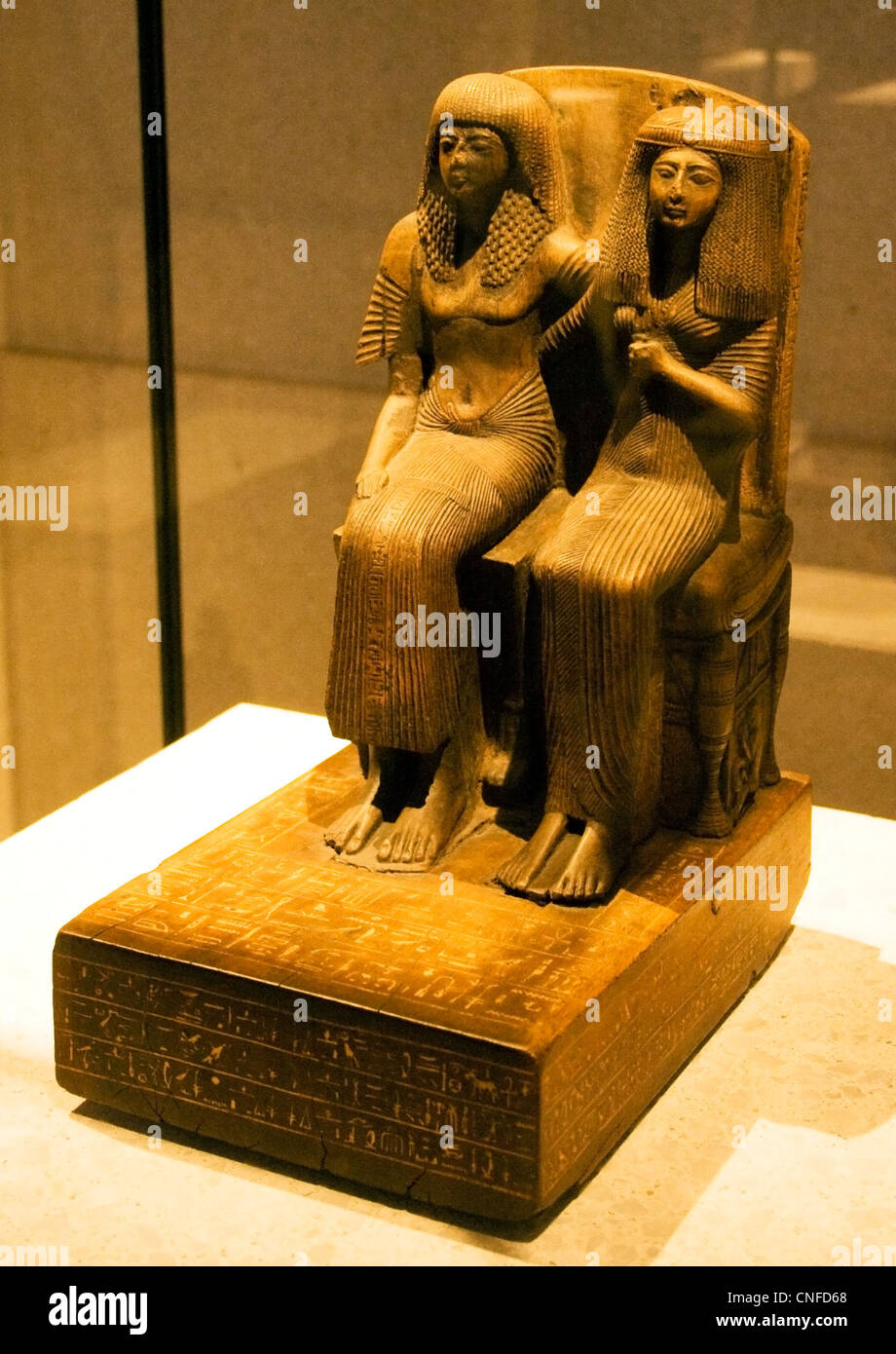 This ancient Egyptian statue depicts Amenemopet, a nobleman, seated ...