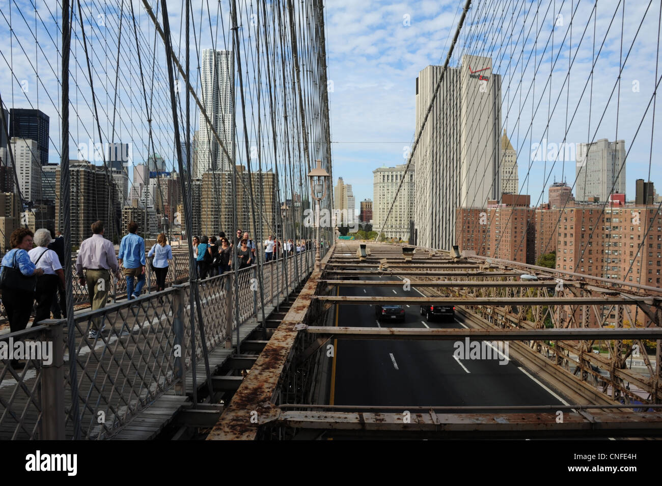 Blue sky view suspension cables road-deck, people walking Brooklyn ...