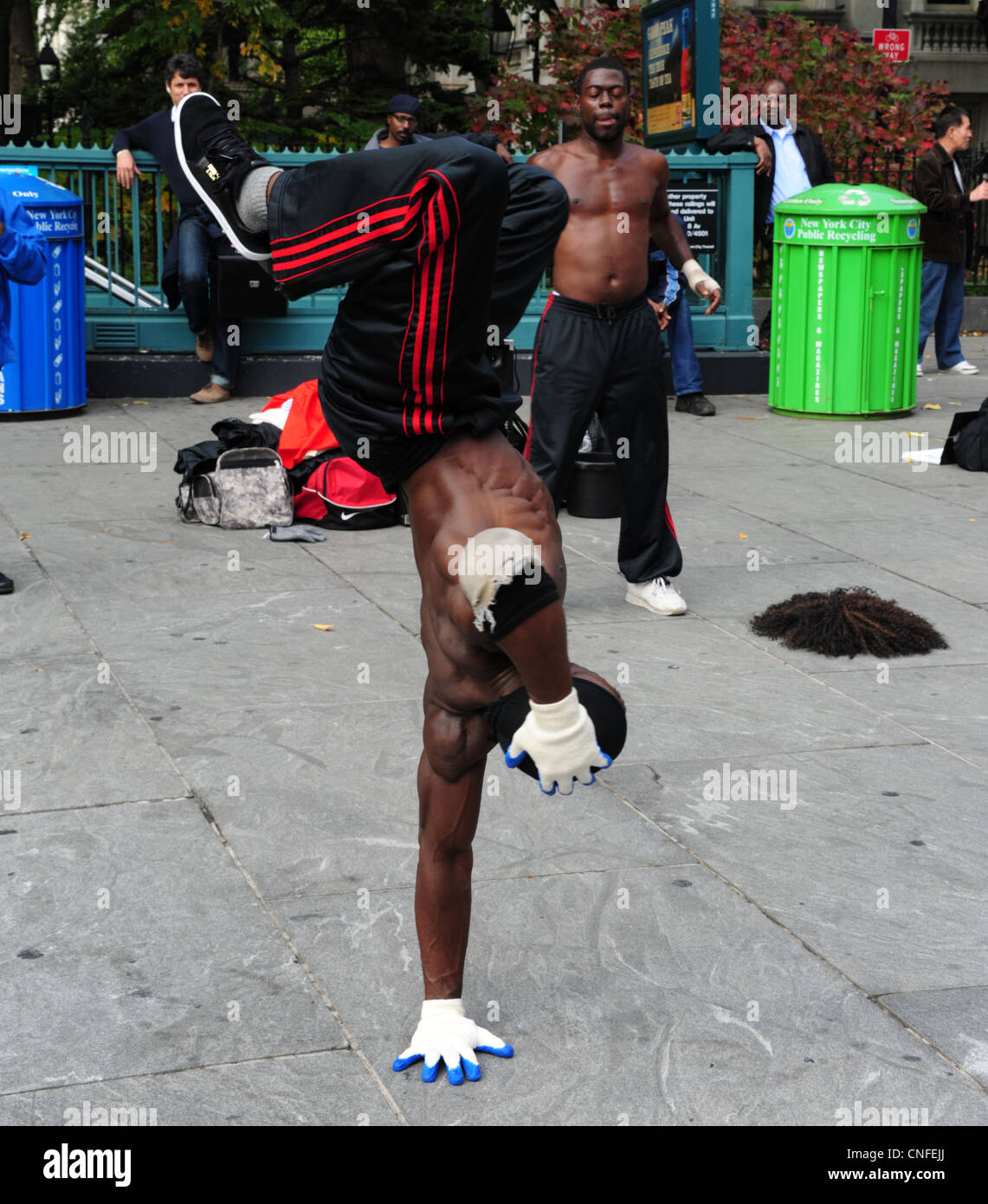 African-American man, white gloves balancing one hand legs upright ...