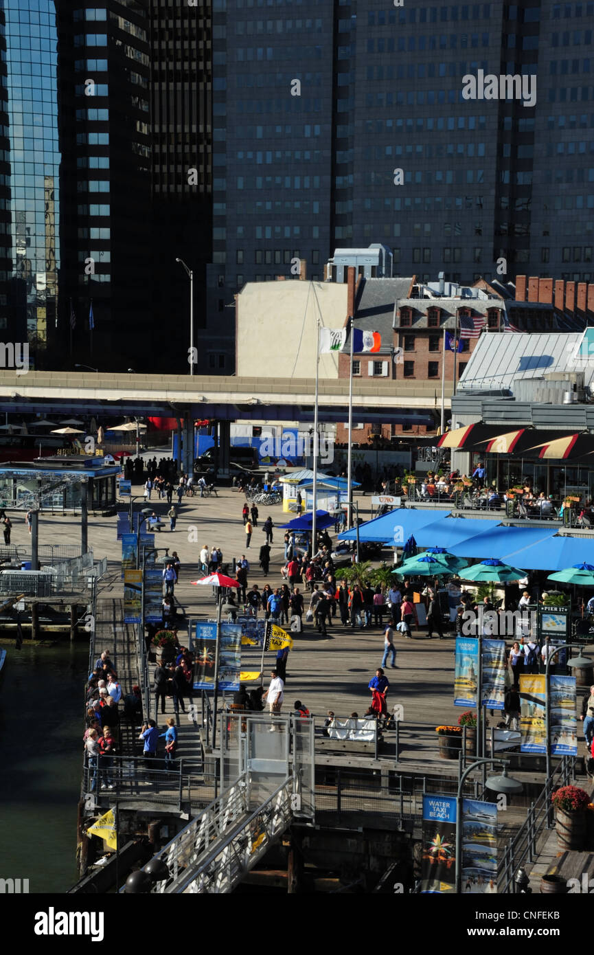 Sun shade portrait, looking down from Pier 17, many people walking ...