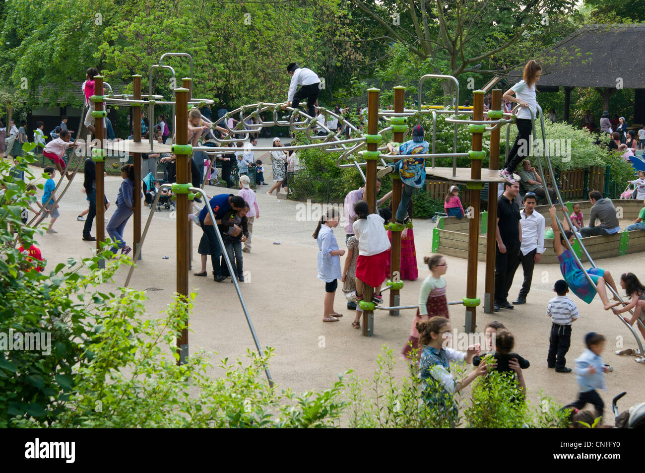 Children playing on a playground at Buttes-Chaumont Park, Paris, France ...
