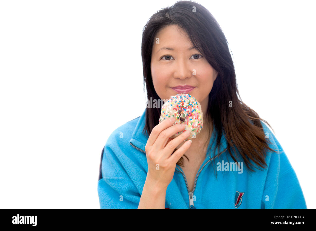 attractive asian lady eating a donut Stock Photo - Alamy