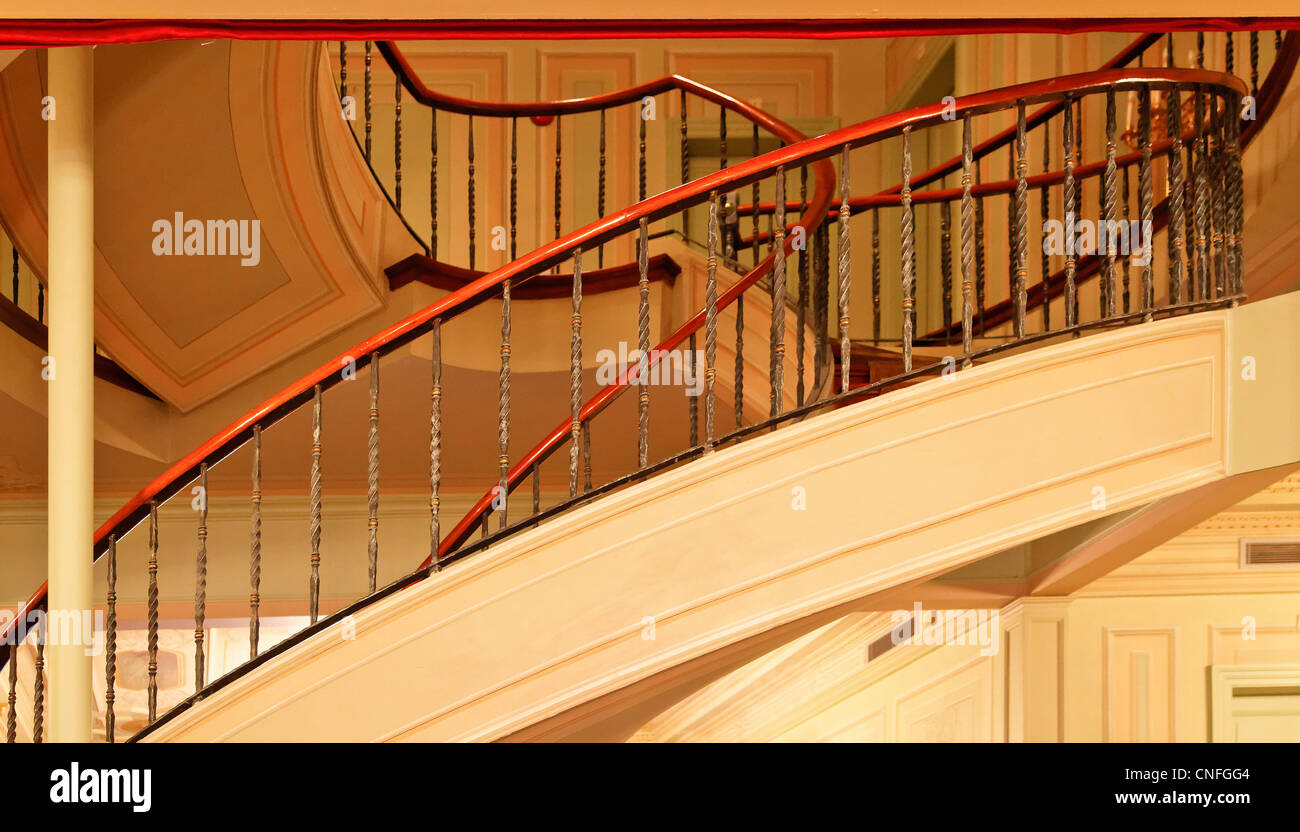 Open staircase of wood handrails and wrought iron rails making ...
