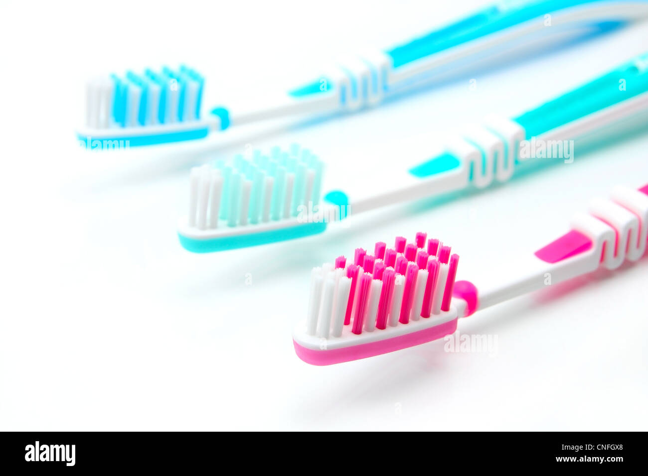 Three toothbrushes red, green and blue on a white background Stock ...