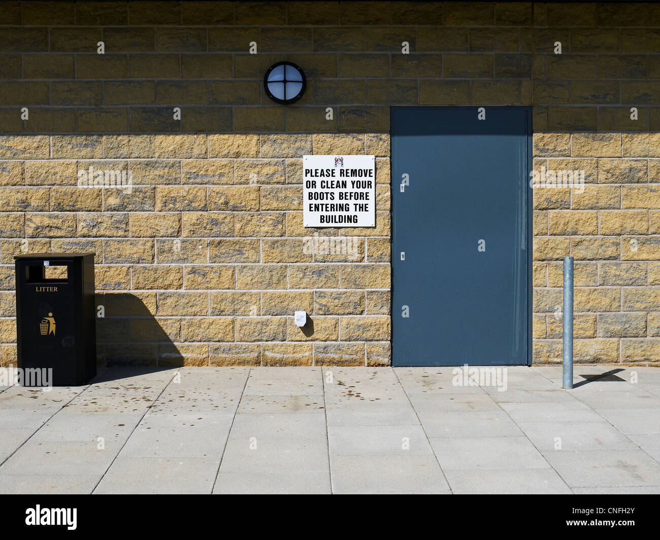 Sport complex warning sign on wall, requesting to remove or clean ...