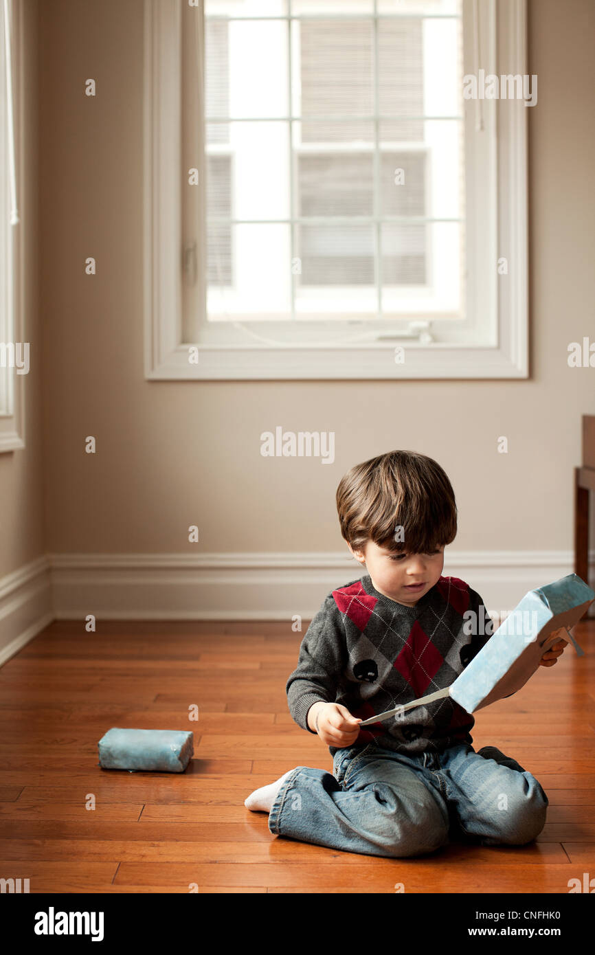 Boy opening a present Stock Photo - Alamy