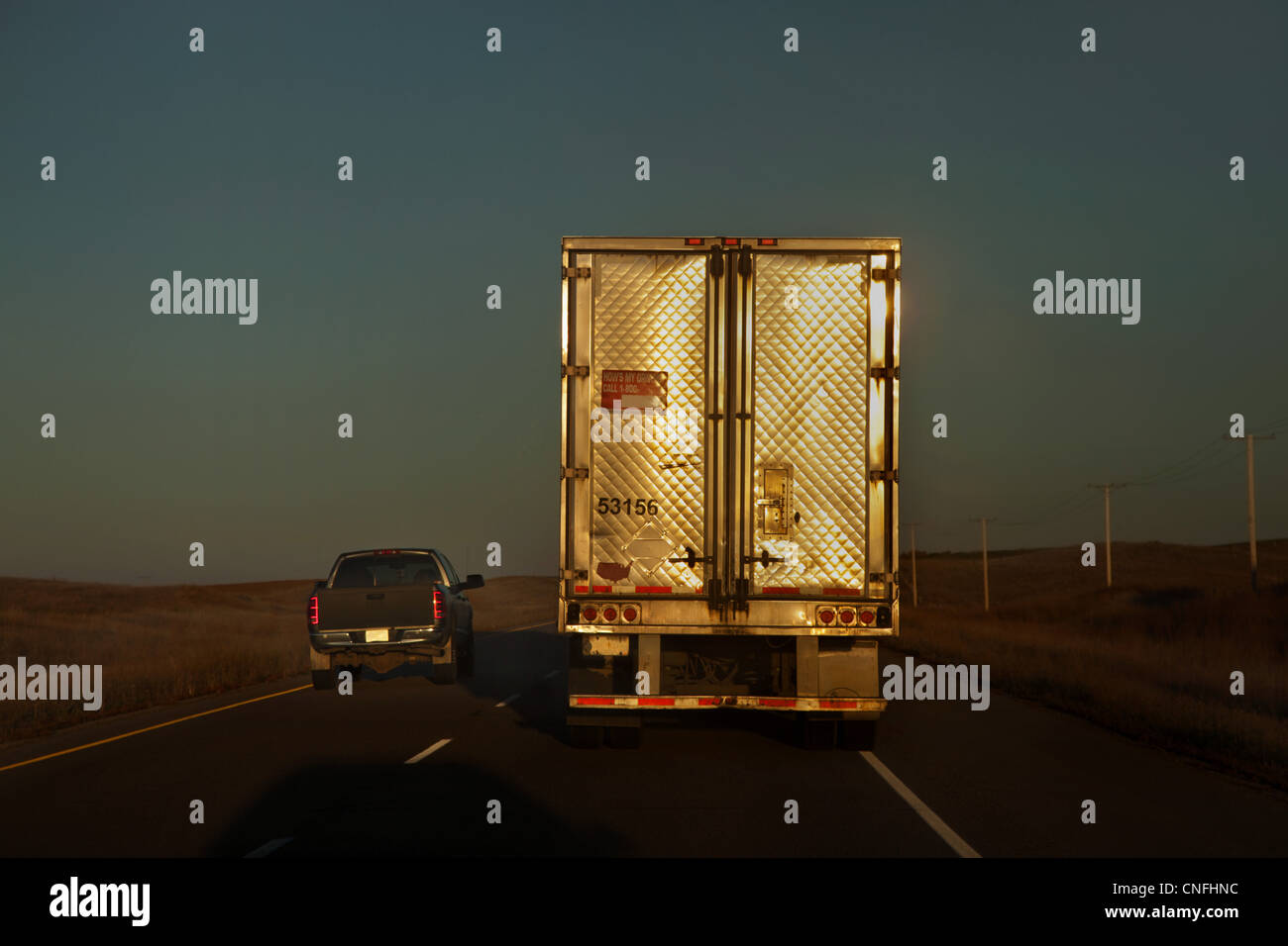 Two trucks on highway Stock Photo - Alamy