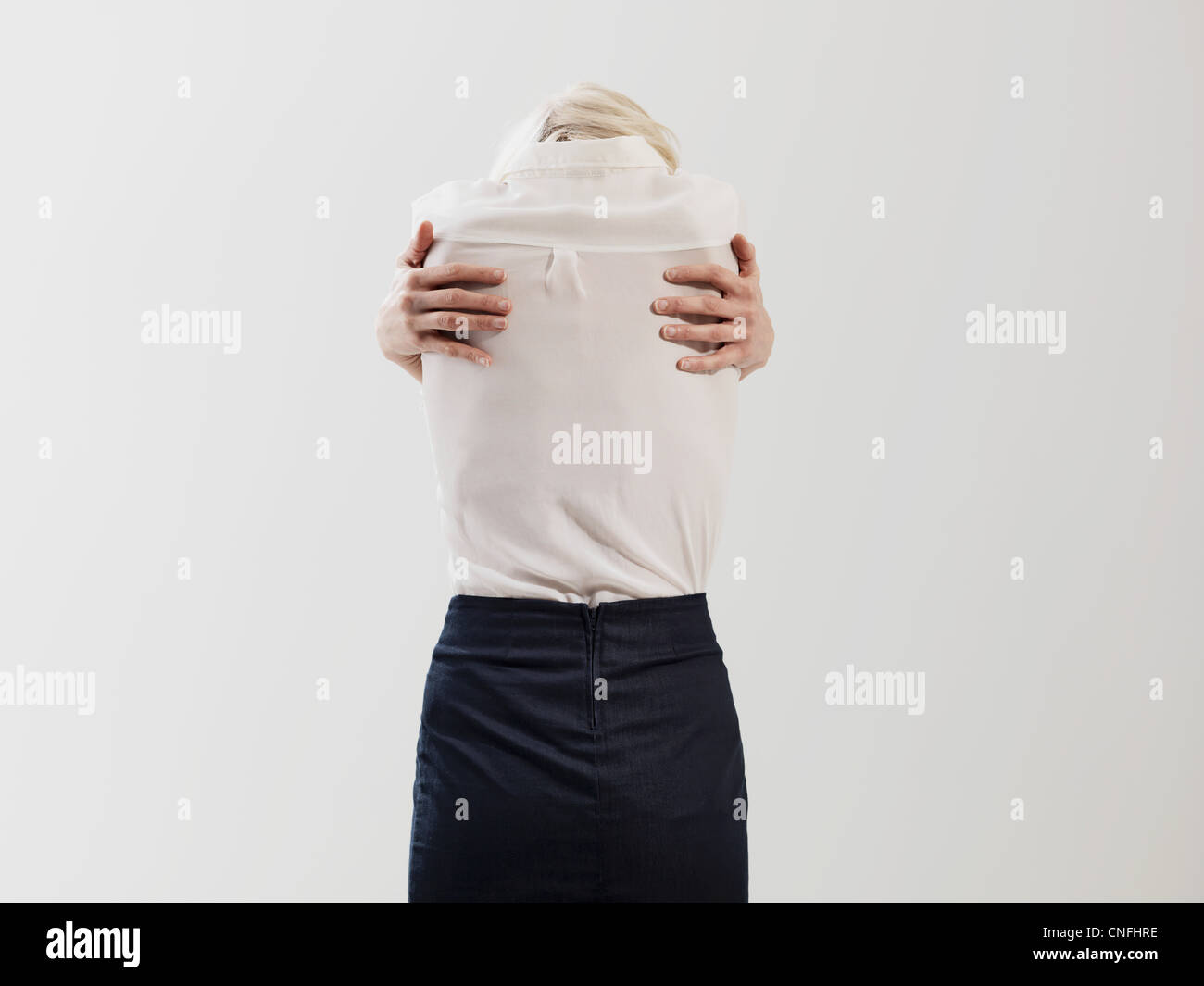 Woman embracing self, studio shot Stock Photo - Alamy