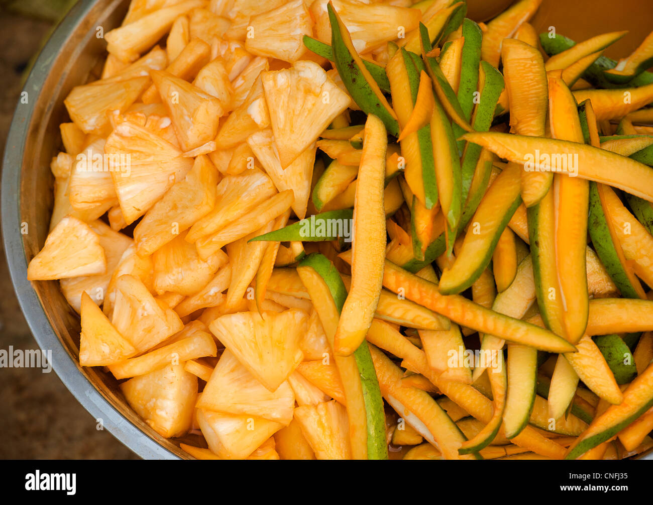 Spicy mango strips and pineapple chunks for sale on a market, Shan ...