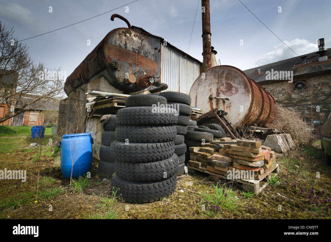 Pile of old disused tyres, rusty metal and old buildings Stock Photo ...