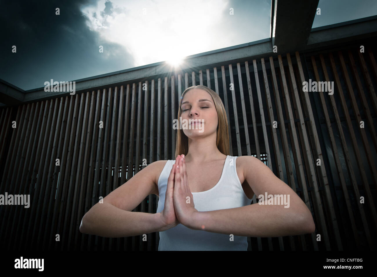 Young woman 20-25 standing and meditating environment yoga meditation ...