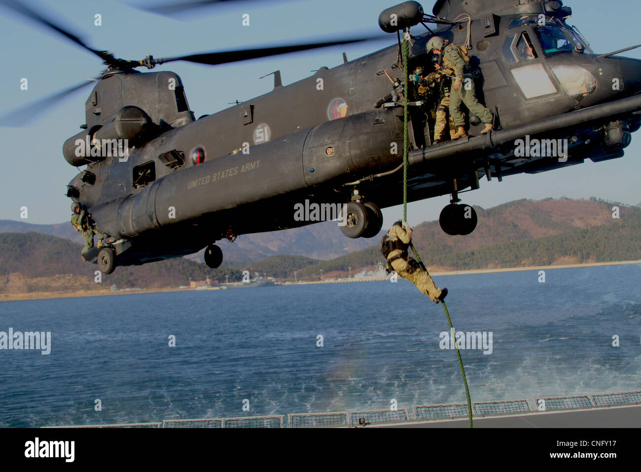 US Navy SEAL team drops from a Chinook helicopter during joint training ...