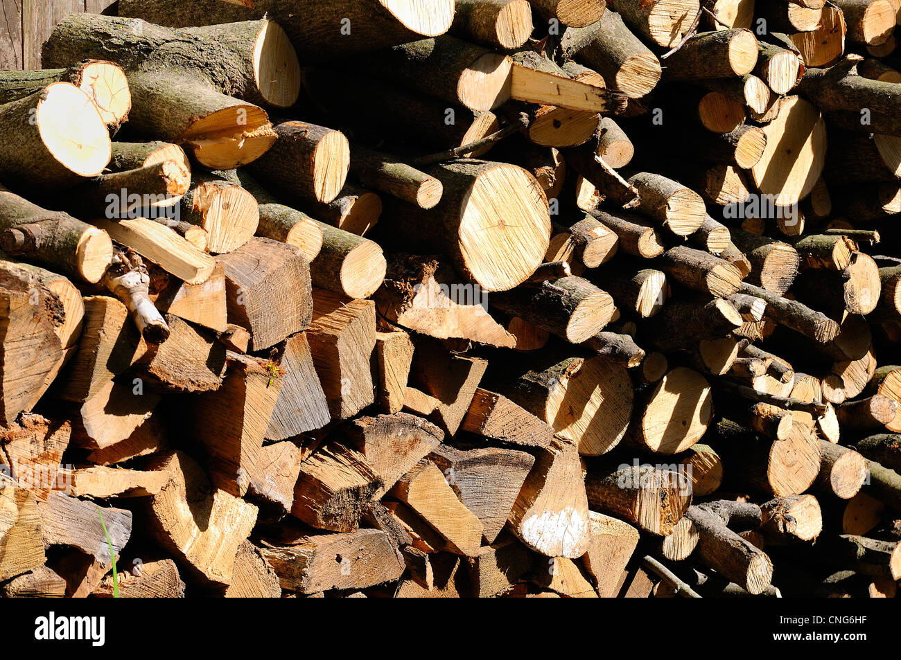 Firewood logs piled high Stock Photo - Alamy