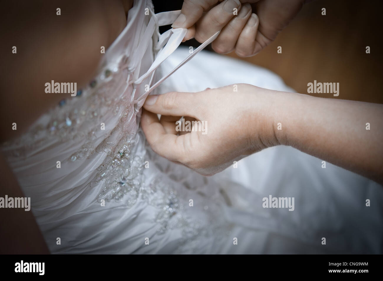 Bride Wedding dress preparation Stock Photo - Alamy