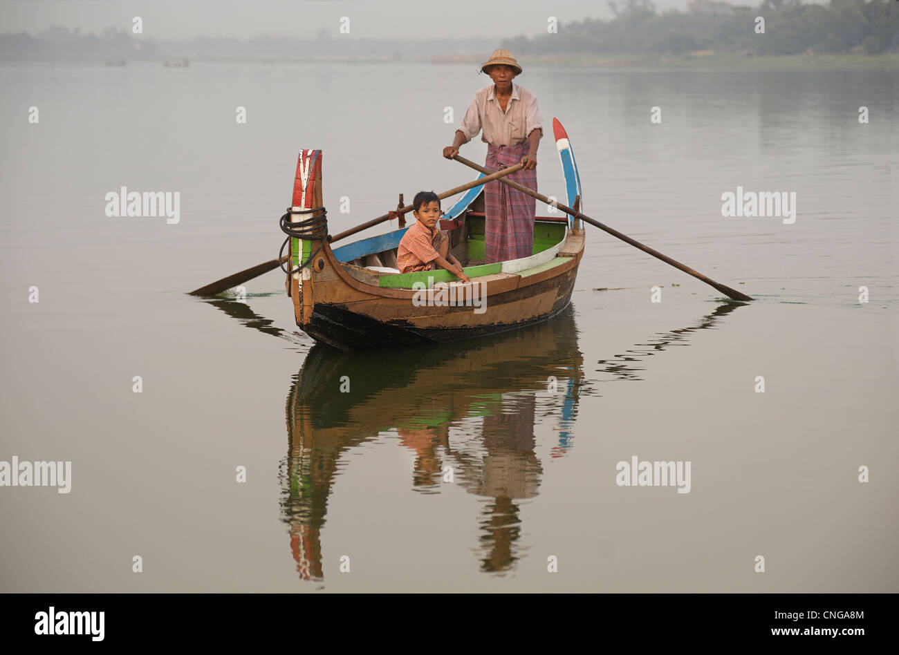 Burmese boy and father in boat, Amarapura, Taugthaman Lake, U Bein ...