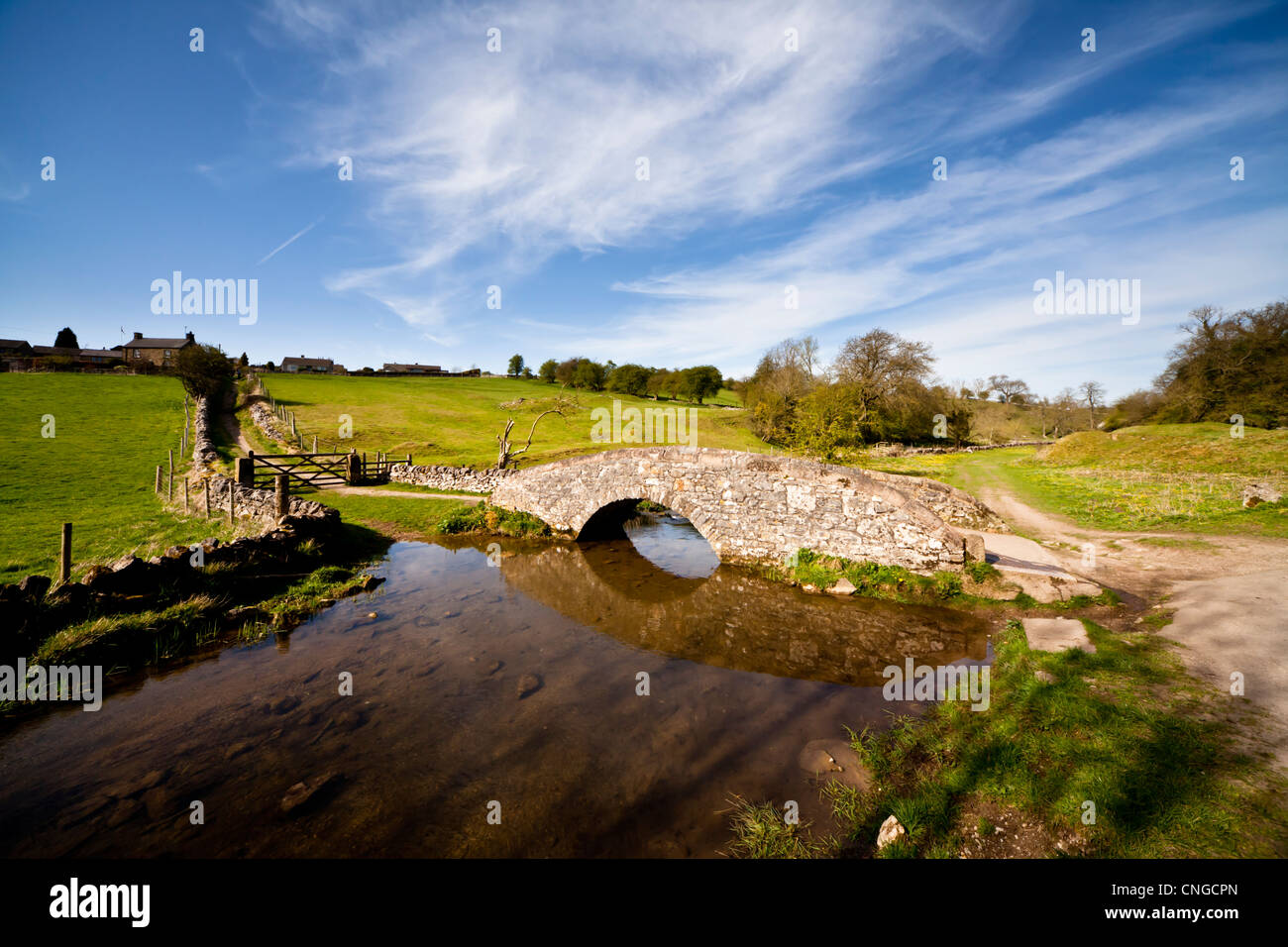 Old limestone bridge over the River Bradford at Youlgrave in the Peak ...