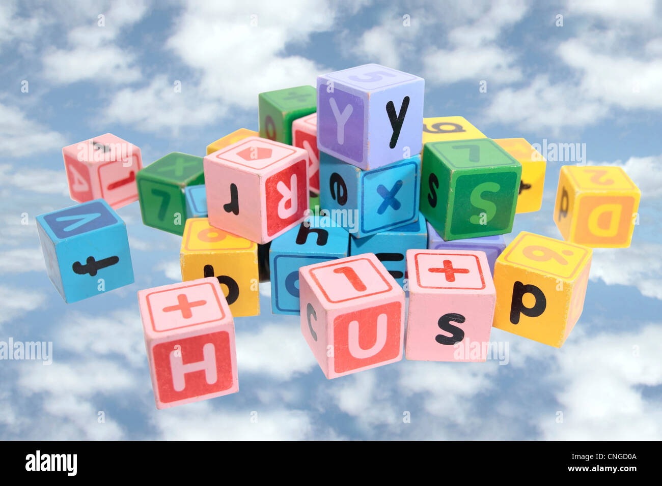 assorted childrens toy letter building blocks against a cloudy ...