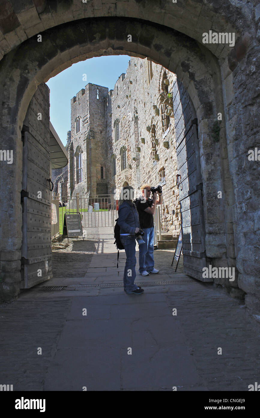 The ancient Chepstow Castle - Tourist photographing detail on gateway ...