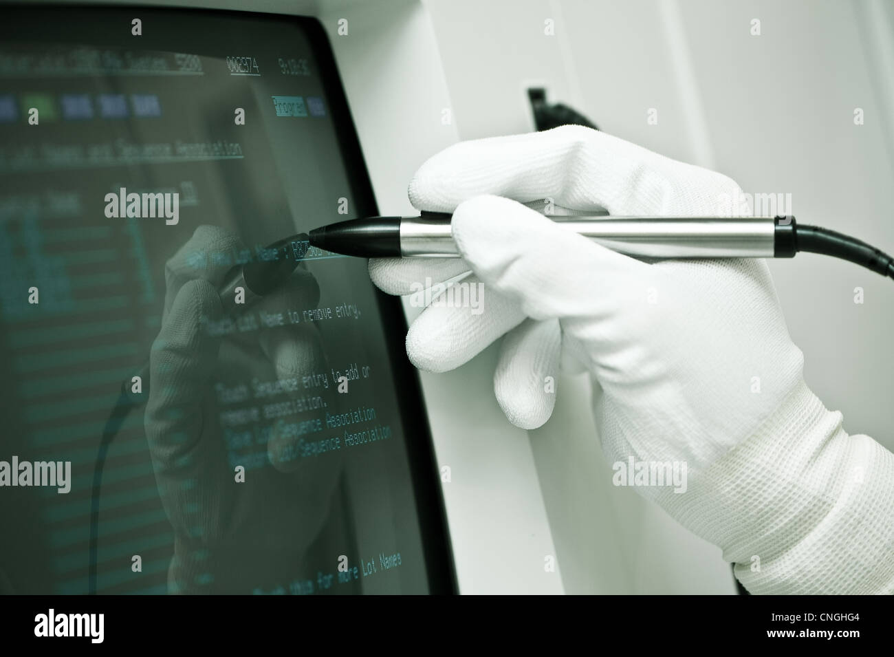 Person in cleanroom working at a computer monitor with a pen Stock ...