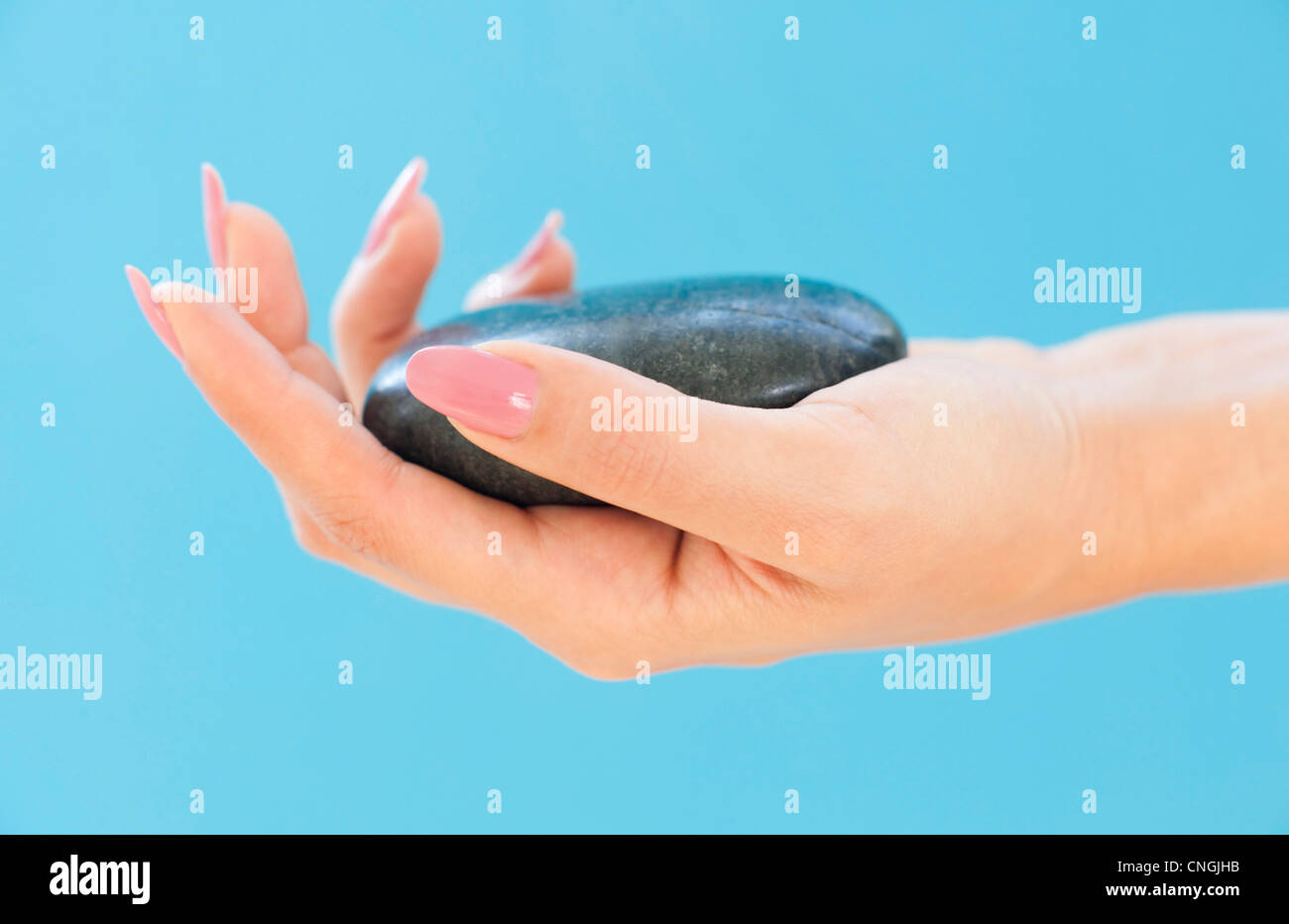 Hand holds a stone hi-res stock photography and images - Alamy